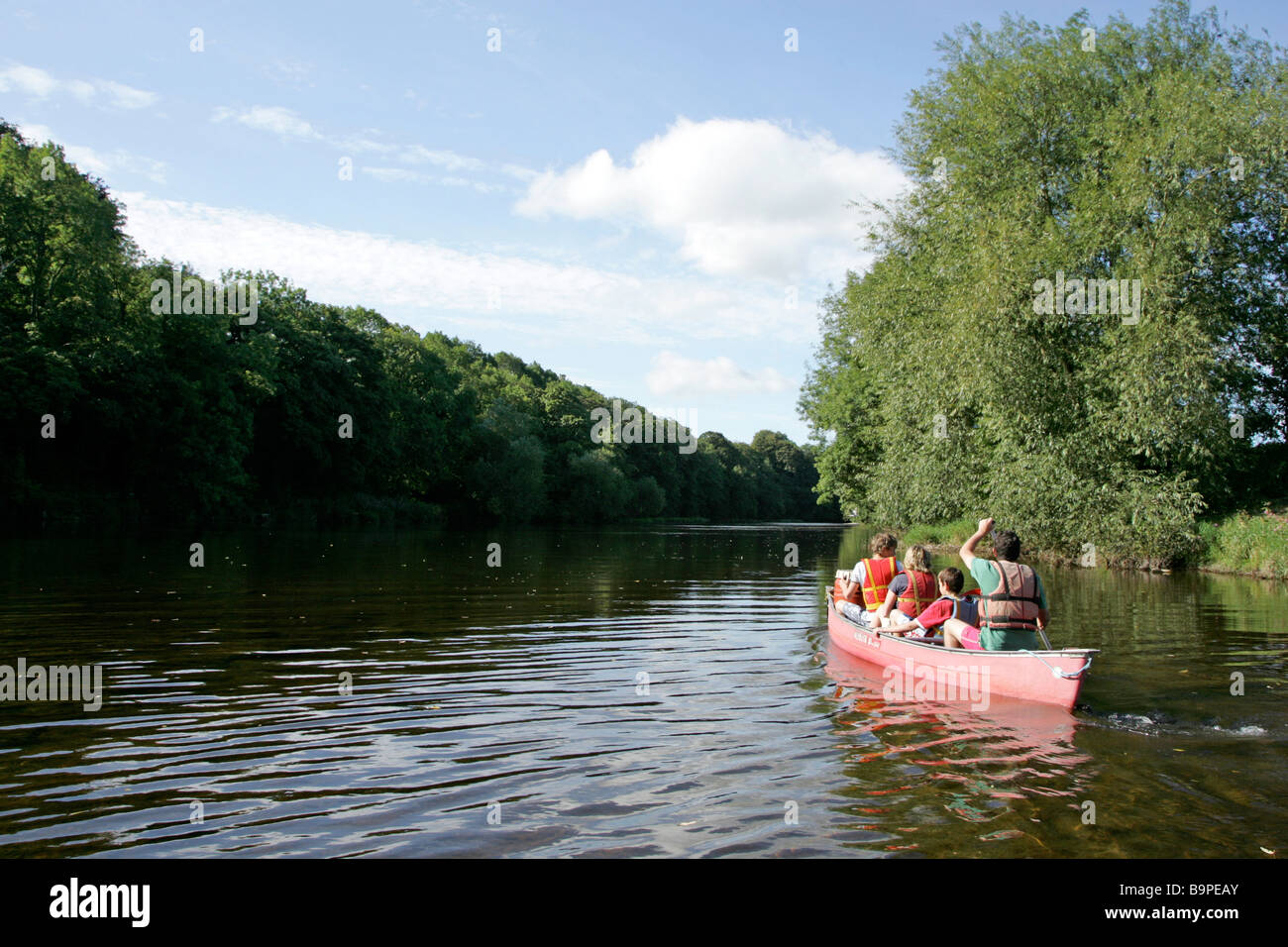 Family Canoeing down a river in summer Stock Photo - Alamy