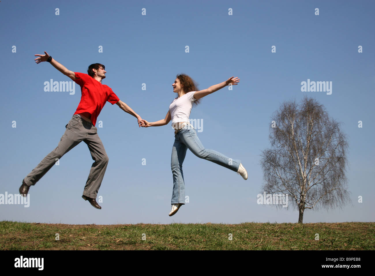 jumping couple. spring Stock Photo - Alamy
