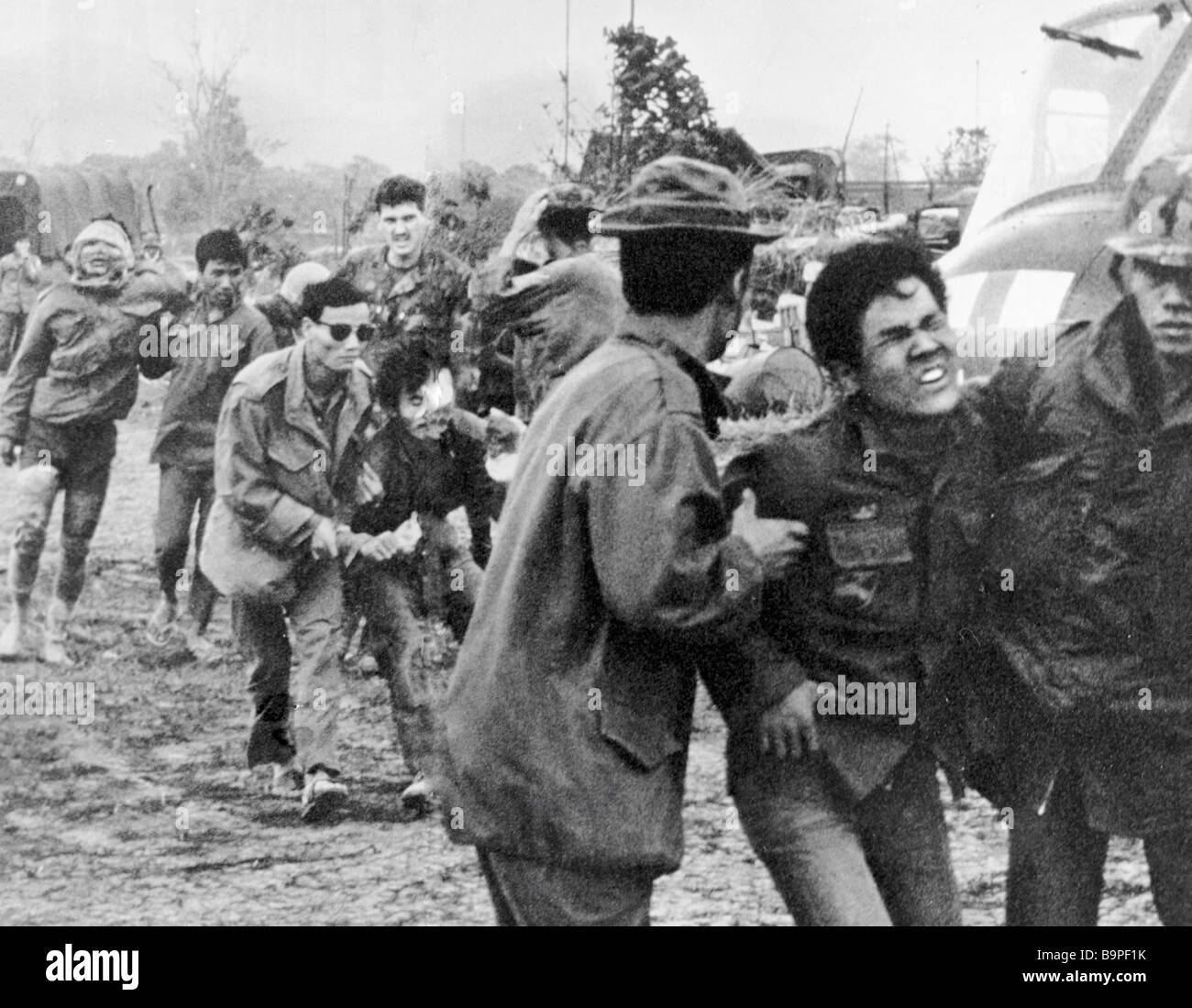 Retreating soldiers of the South Vietnam Army evacuate wounded from ...