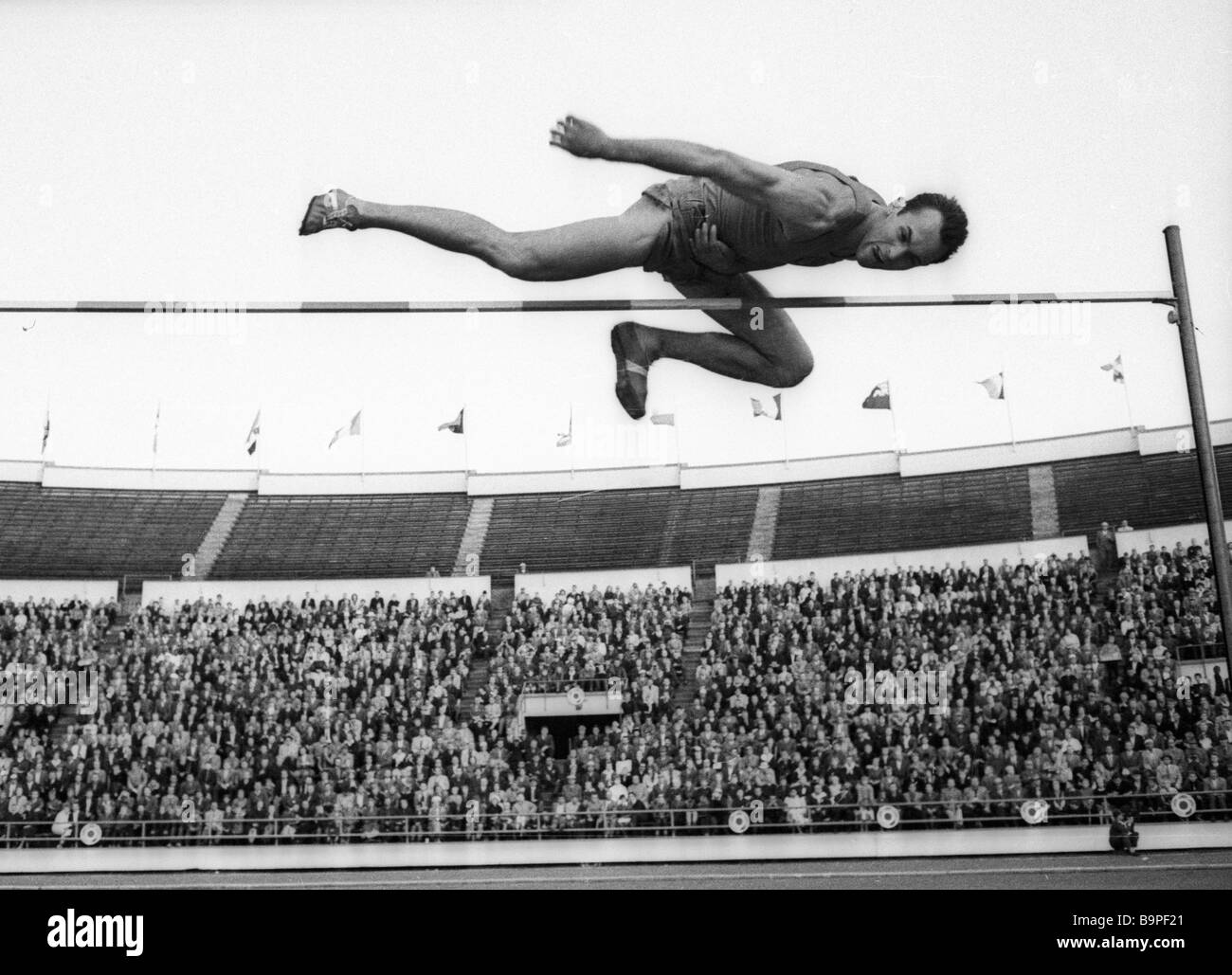 Track and field athlete Valeri Brumel in high jump on the Lenin stadium ...
