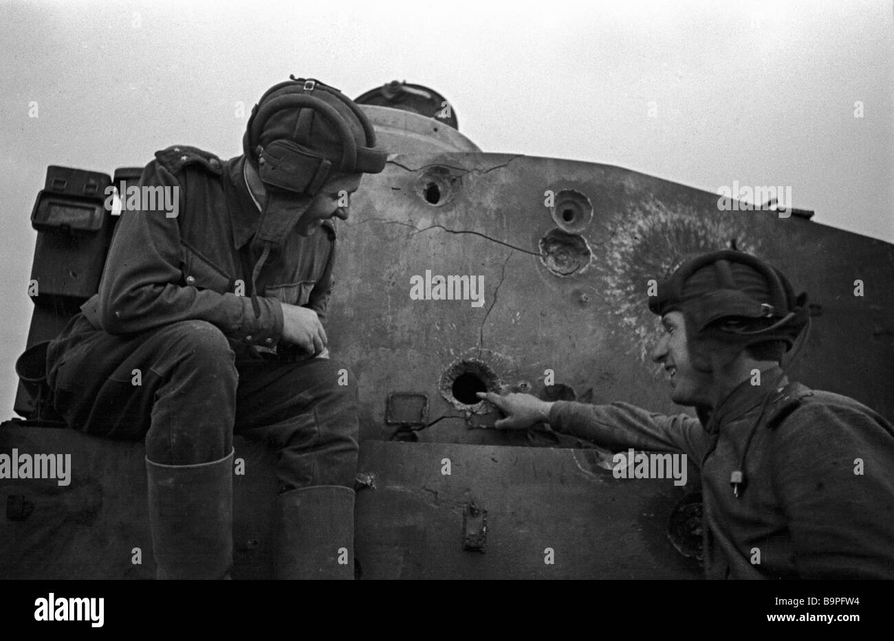 Two Soviet tankmen sitting on a disabled Tiger tank The Kursk Bulge ...