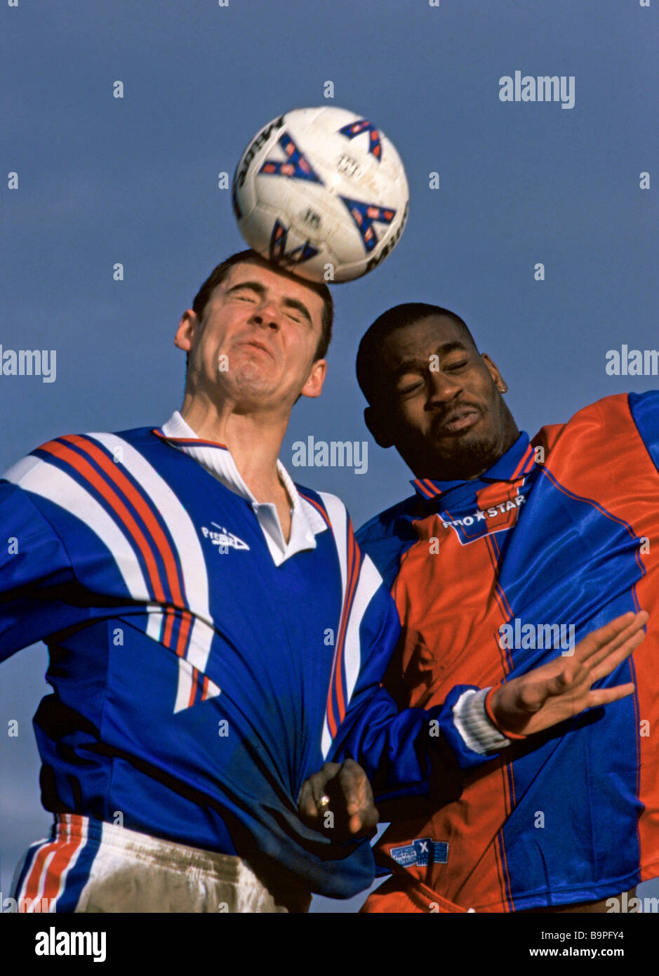 football soccer header heads ball action sports Stock Photo - Alamy