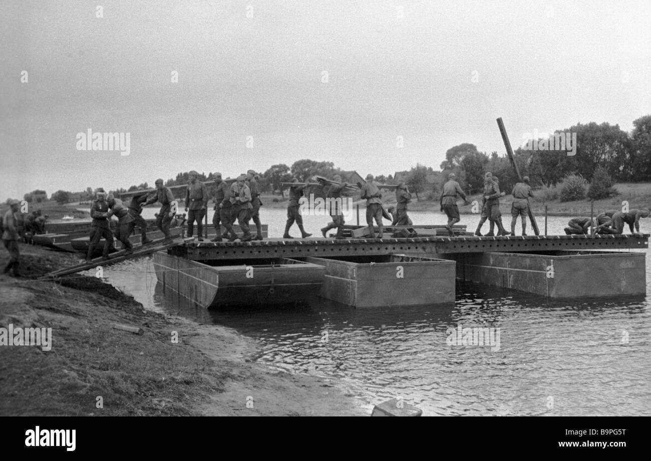 Soldiers of Soviet engineer troops building a ponton bridge Stock Photo ...