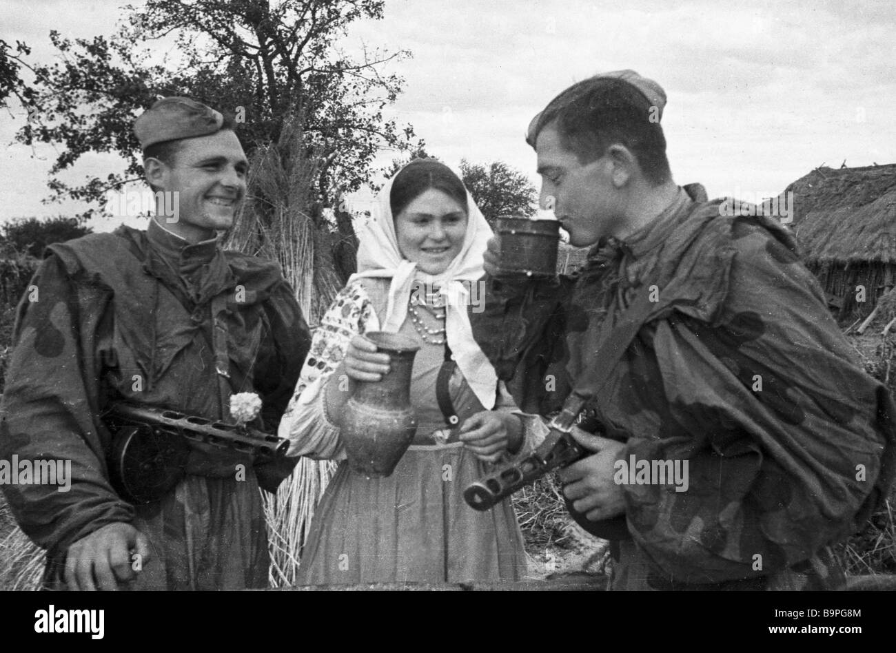 A peasant treats Soviet officers to milk Stock Photo - Alamy