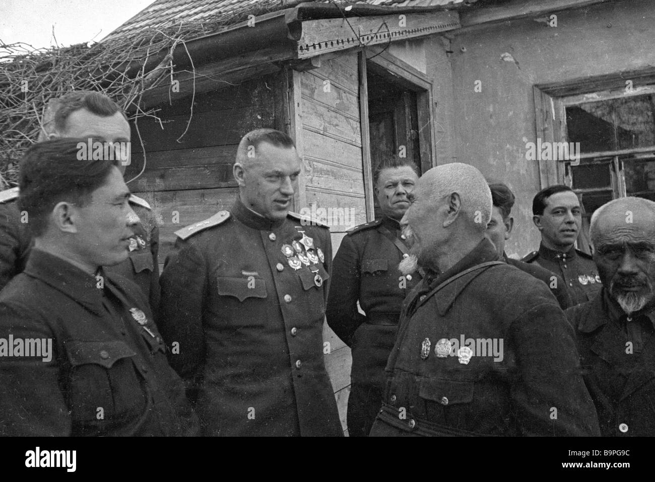 Colonel General Rokossovsky third to the left talks to delegates who ...