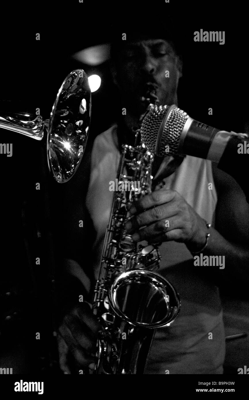 sax and trumpet playing into stage microphone Stock Photo - Alamy