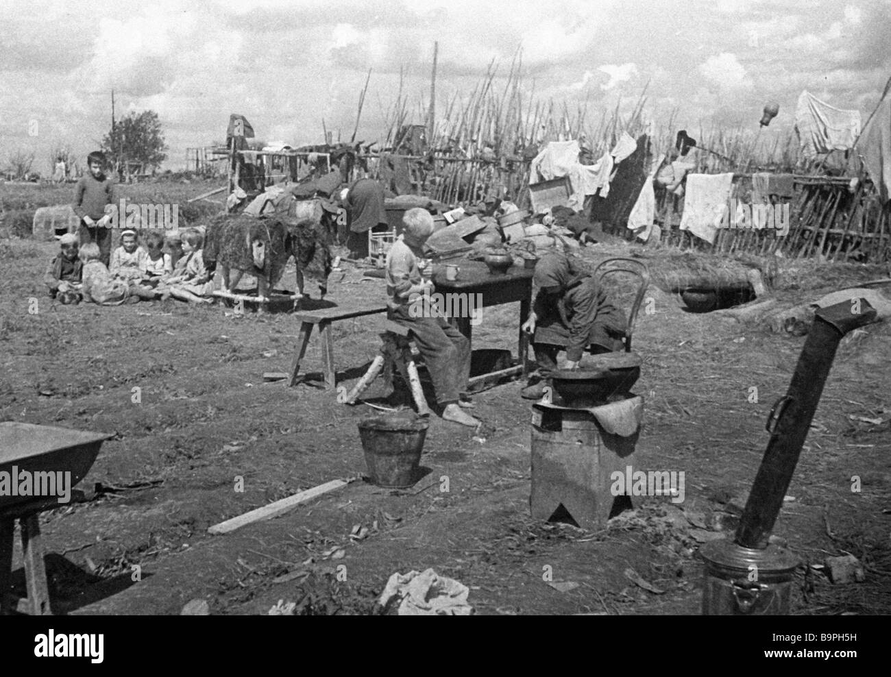 Collective farmers of Staroye Ustinovo in their village destroyed by ...