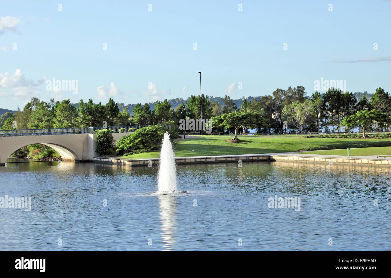 Man made lake with water feature and road bridge Stock Photo - Alamy