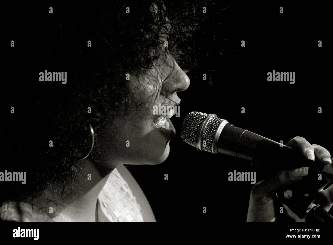 female singer with mike black and white image Stock Photo - Alamy