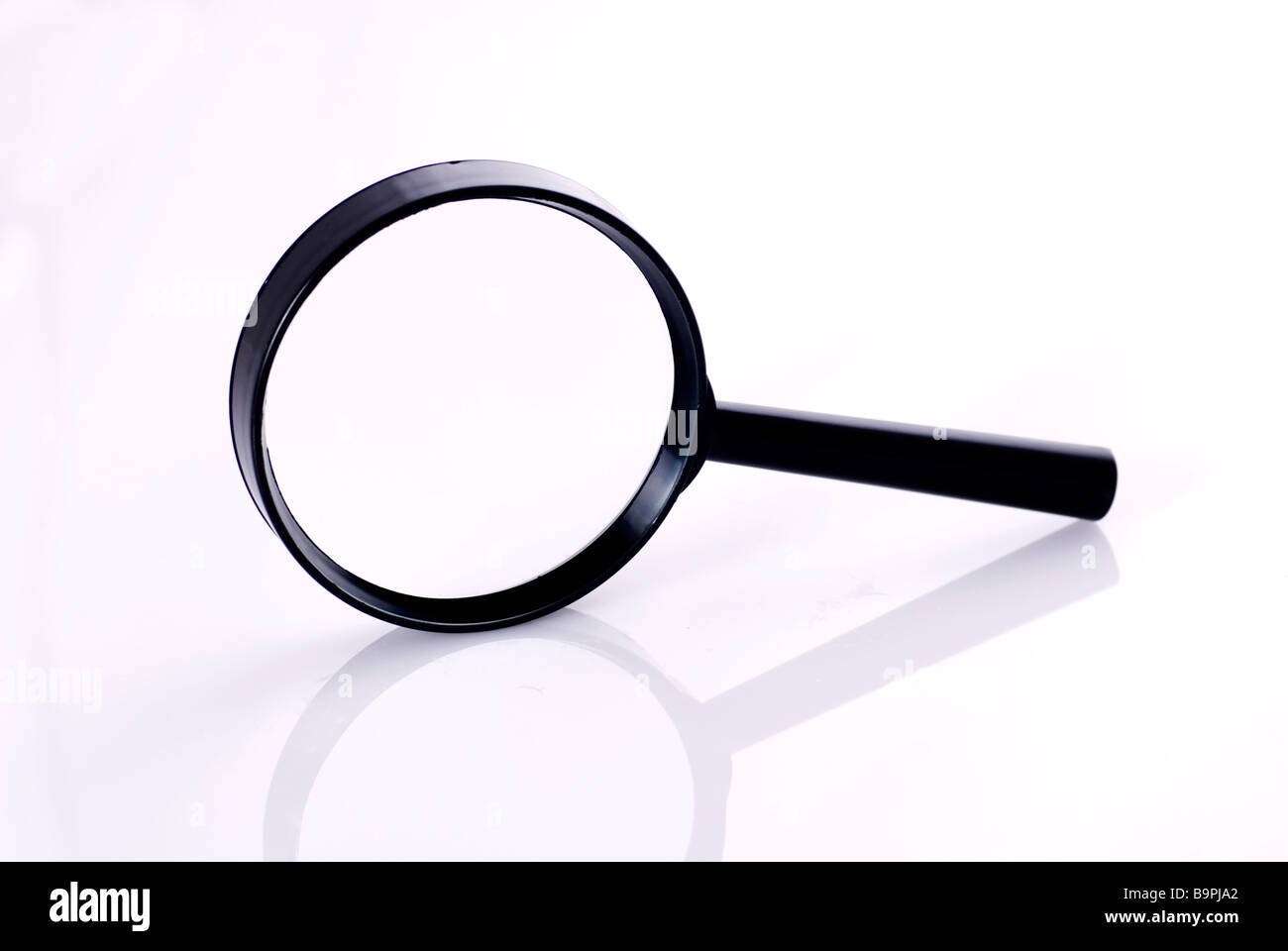 Side view of a magnifying glass on a white background Stock Photo - Alamy