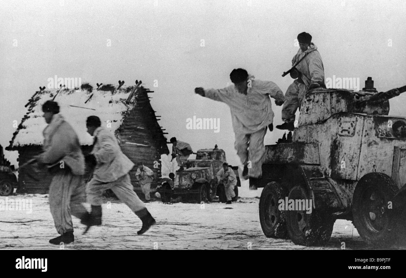 Soldiers jumping off an armored vehicle and rushing into attack near ...