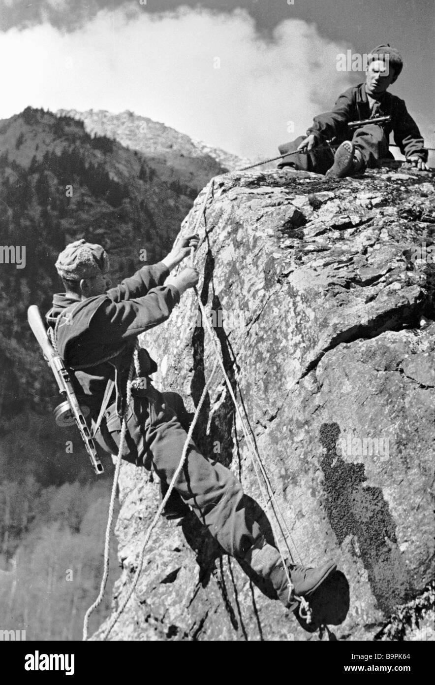 A Soviet soldier climbing a steep rock in the Carpathians The 4th ...