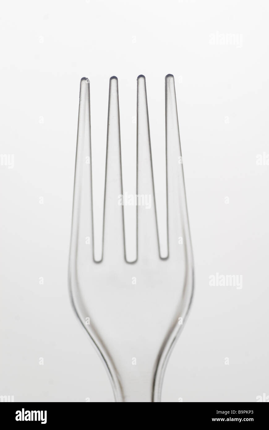Clear plastic fork against a white background Stock Photo - Alamy
