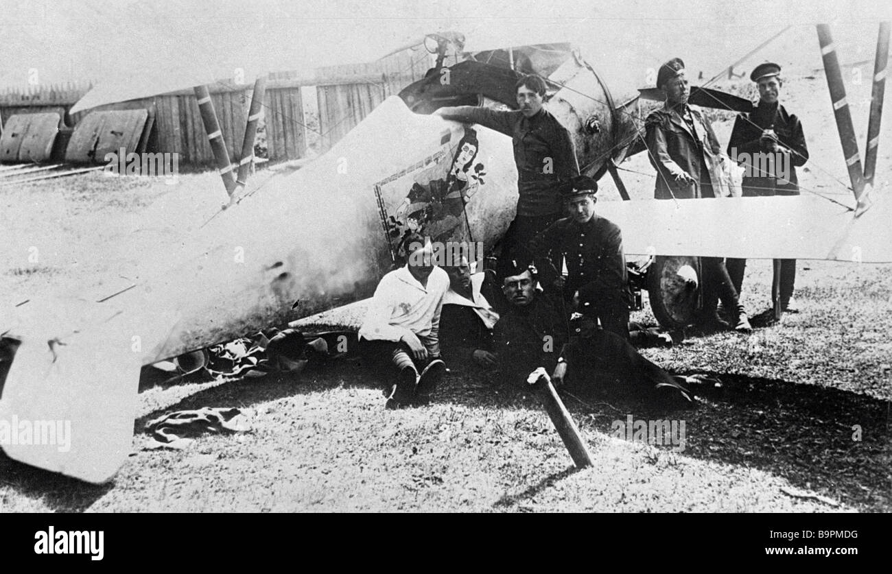 A group of the Red Army pilots near an airplane on aerodrome near ...