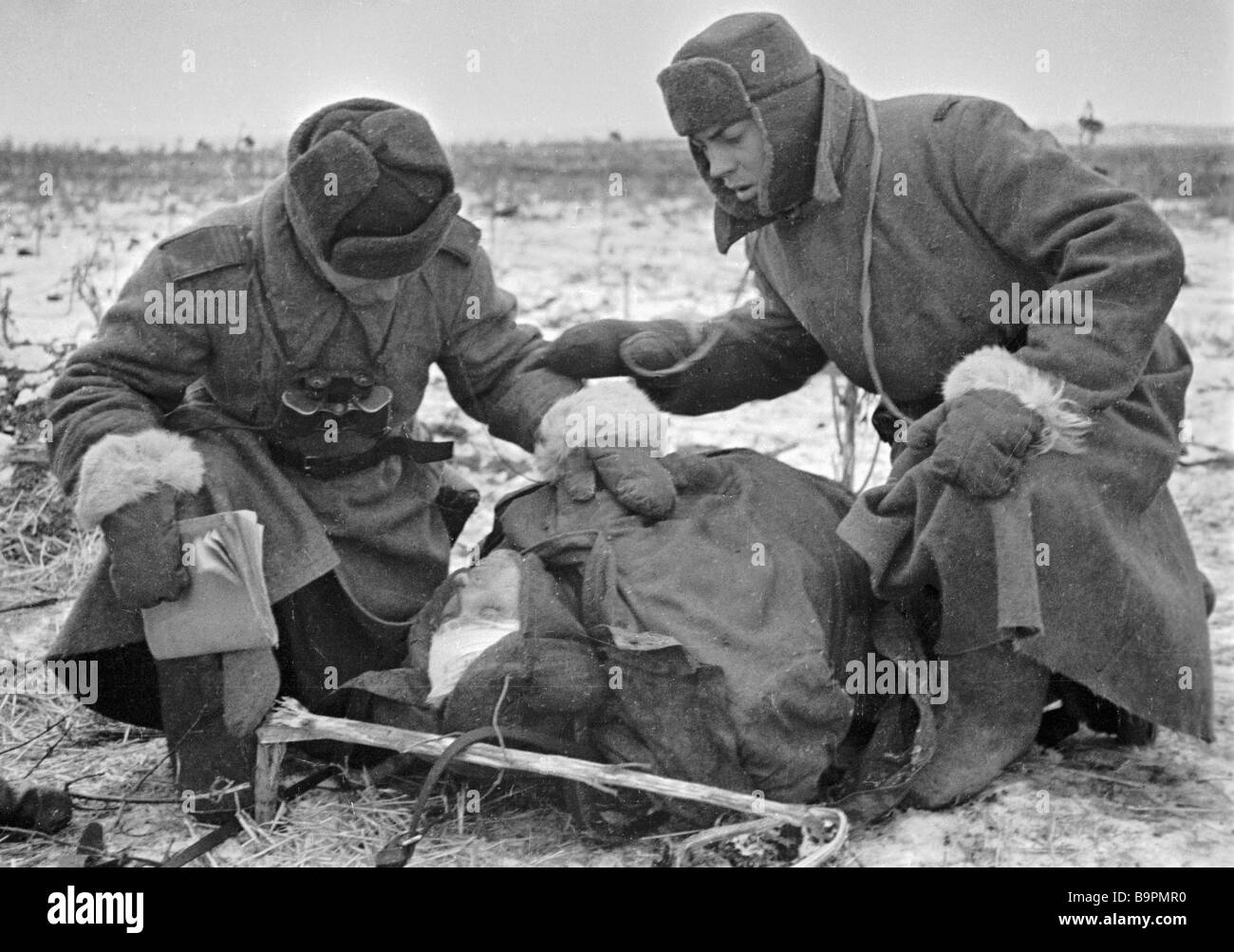 Two Soviet soldiers bending over a dead comrade The 3rd Ukrainian front ...