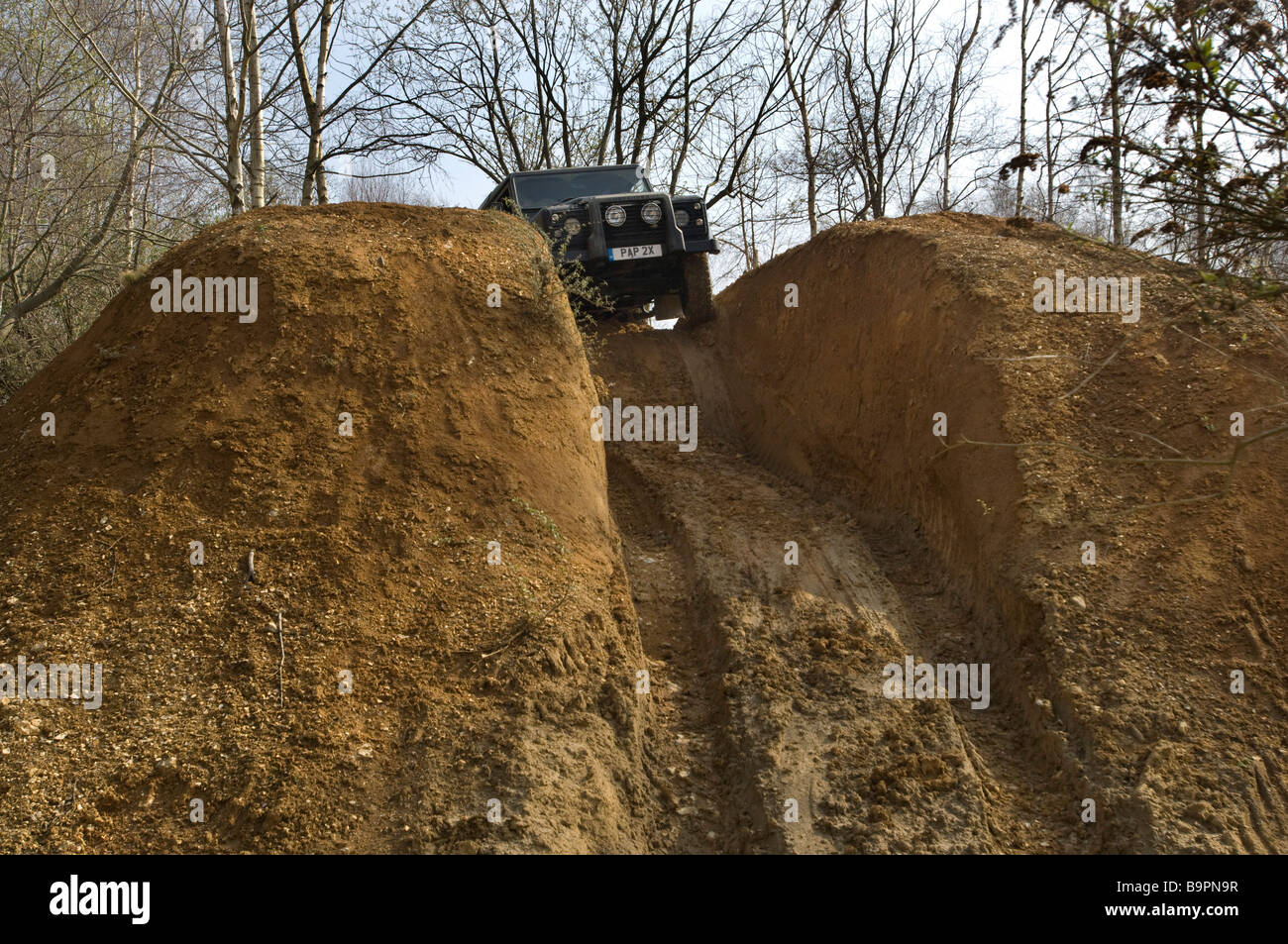 A Land Rover Defender 90 about to descend a steep hill on an offroad ...