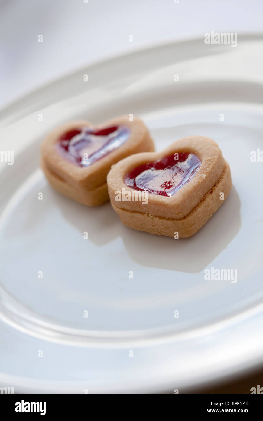 Two heart shaped jam tarts on a plate Stock Photo - Alamy