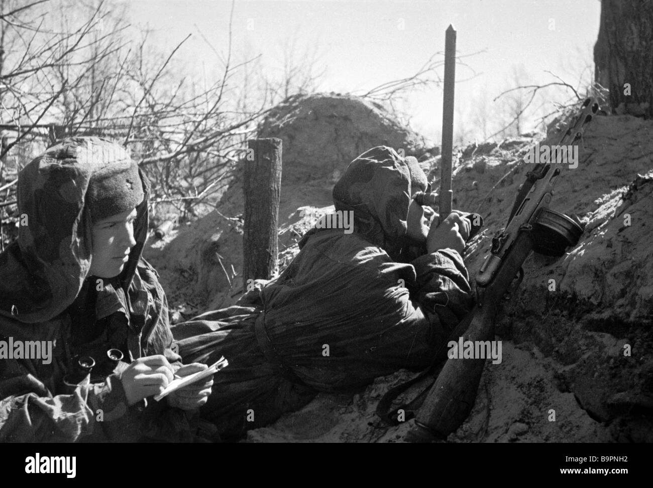 Two Soviet soldiers shooting at the enemy from a trench Stock Photo - Alamy