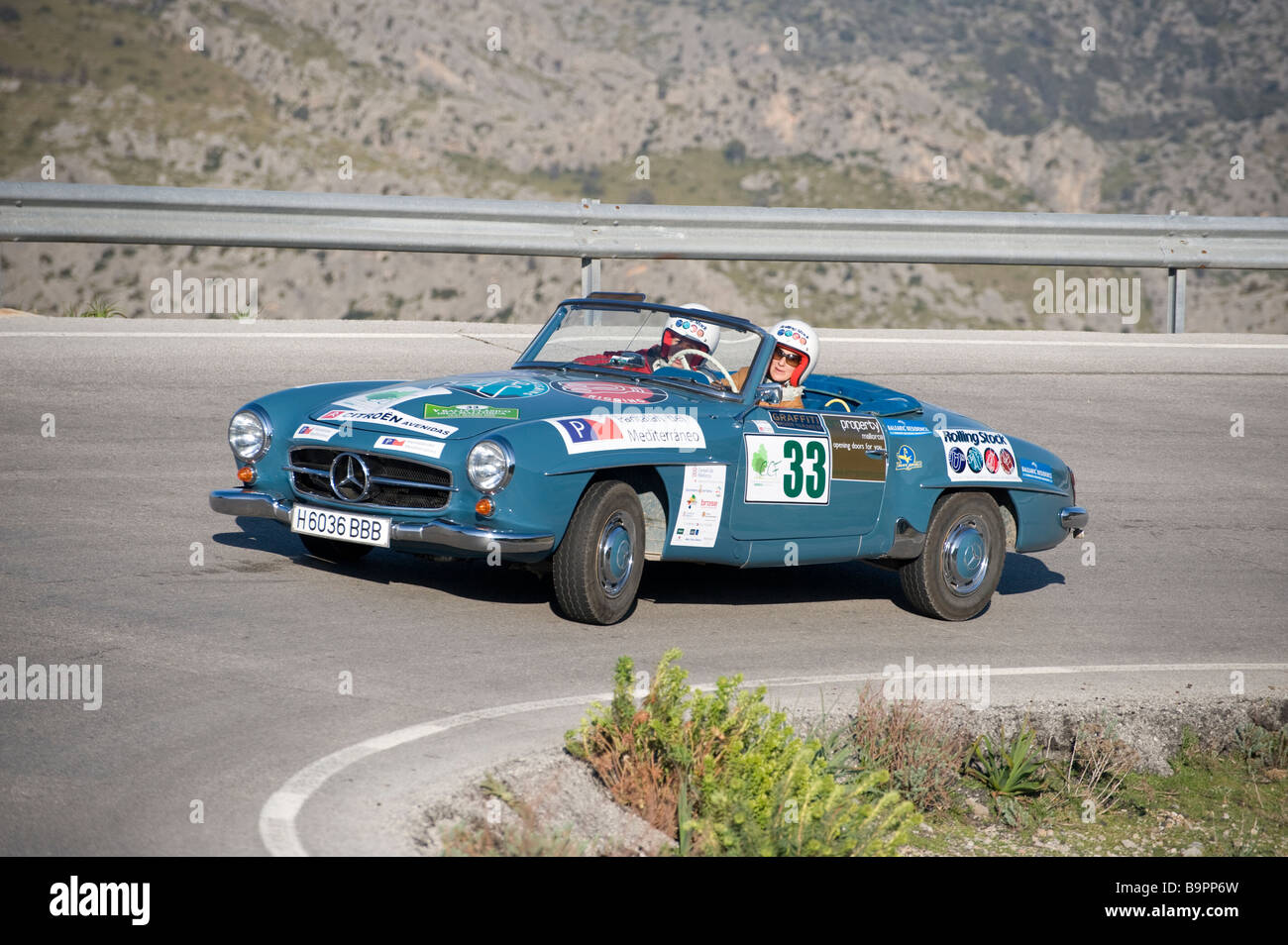 Blue 1955 Mercedes 190 SL grand touring convertible car racing in the ...