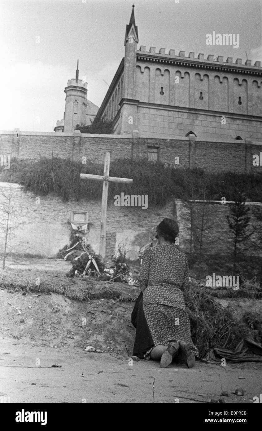A woman praying on a tomb near Lublin s prison Poland Thousands of ...