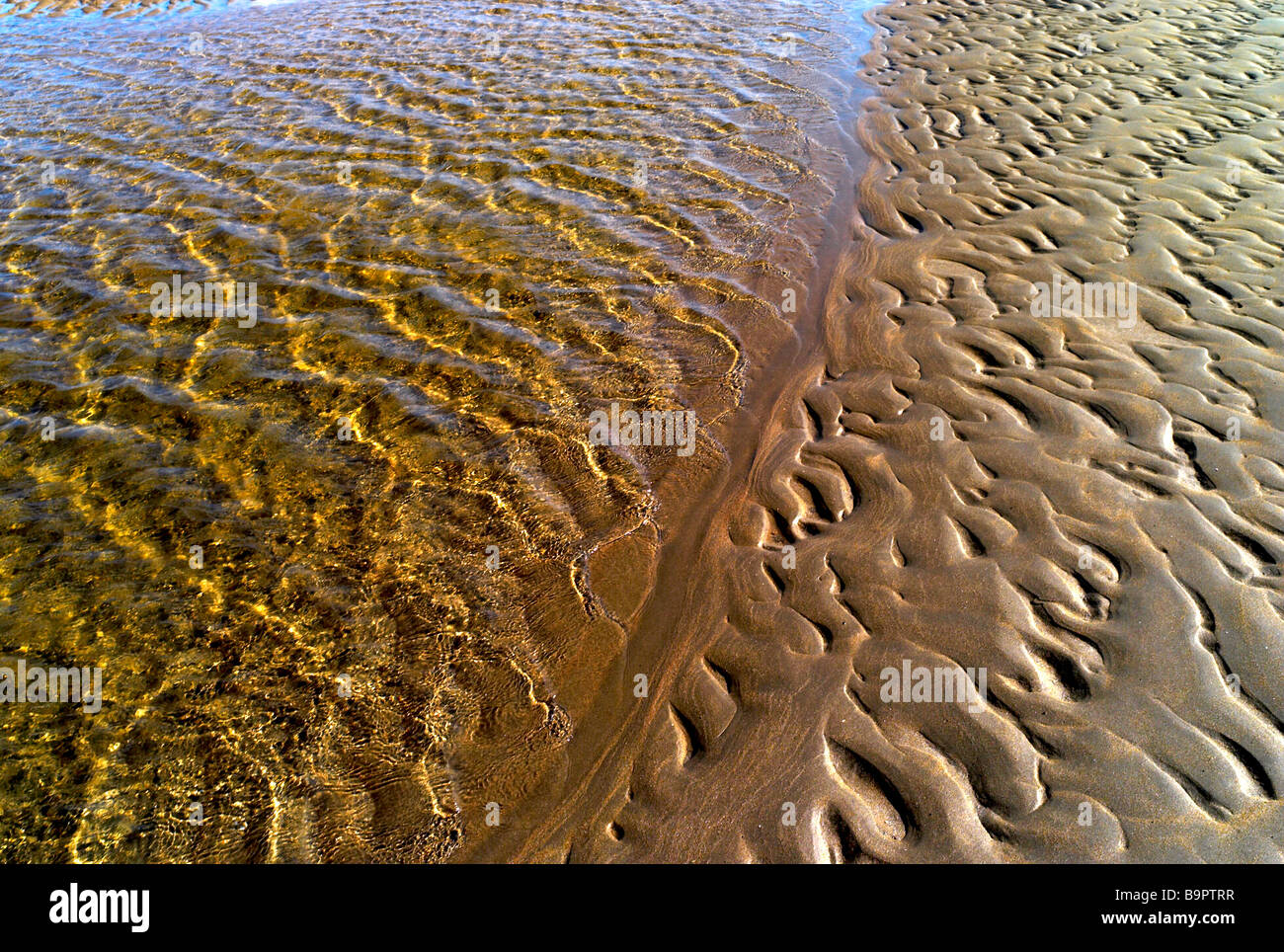 Ripples in the sand beside the water on a beach in Ireland Stock Photo ...