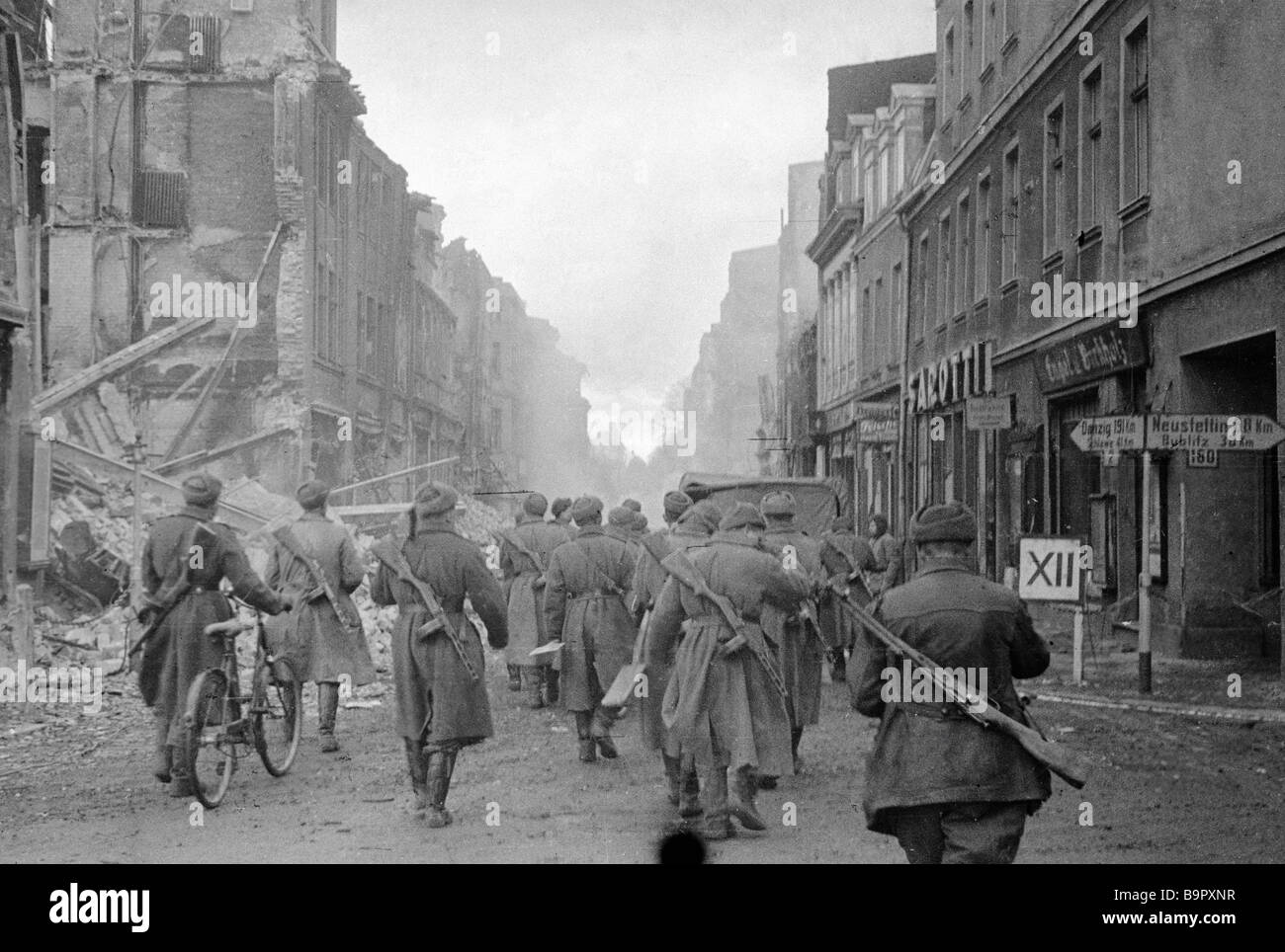Soviet soldiers marching along the streets of destroyed Koslin in ...