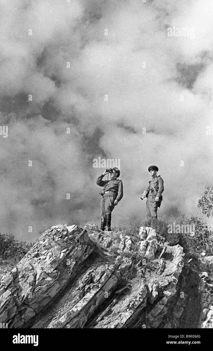 Border patrol observes border stretch through binoculars Stock Photo ...