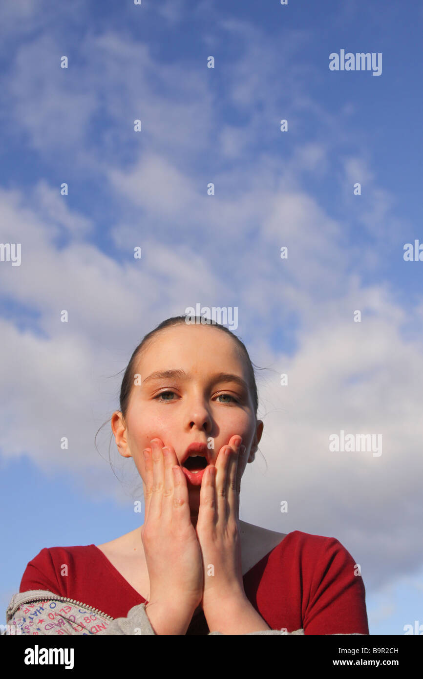 Young girl looking shocked Stock Photo - Alamy