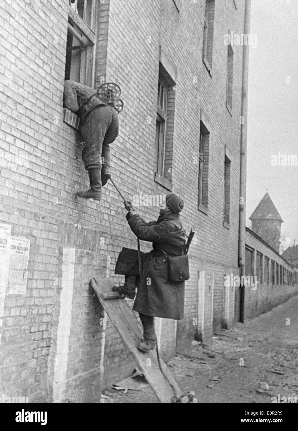 Communications men working in an occupied building Stock Photo - Alamy