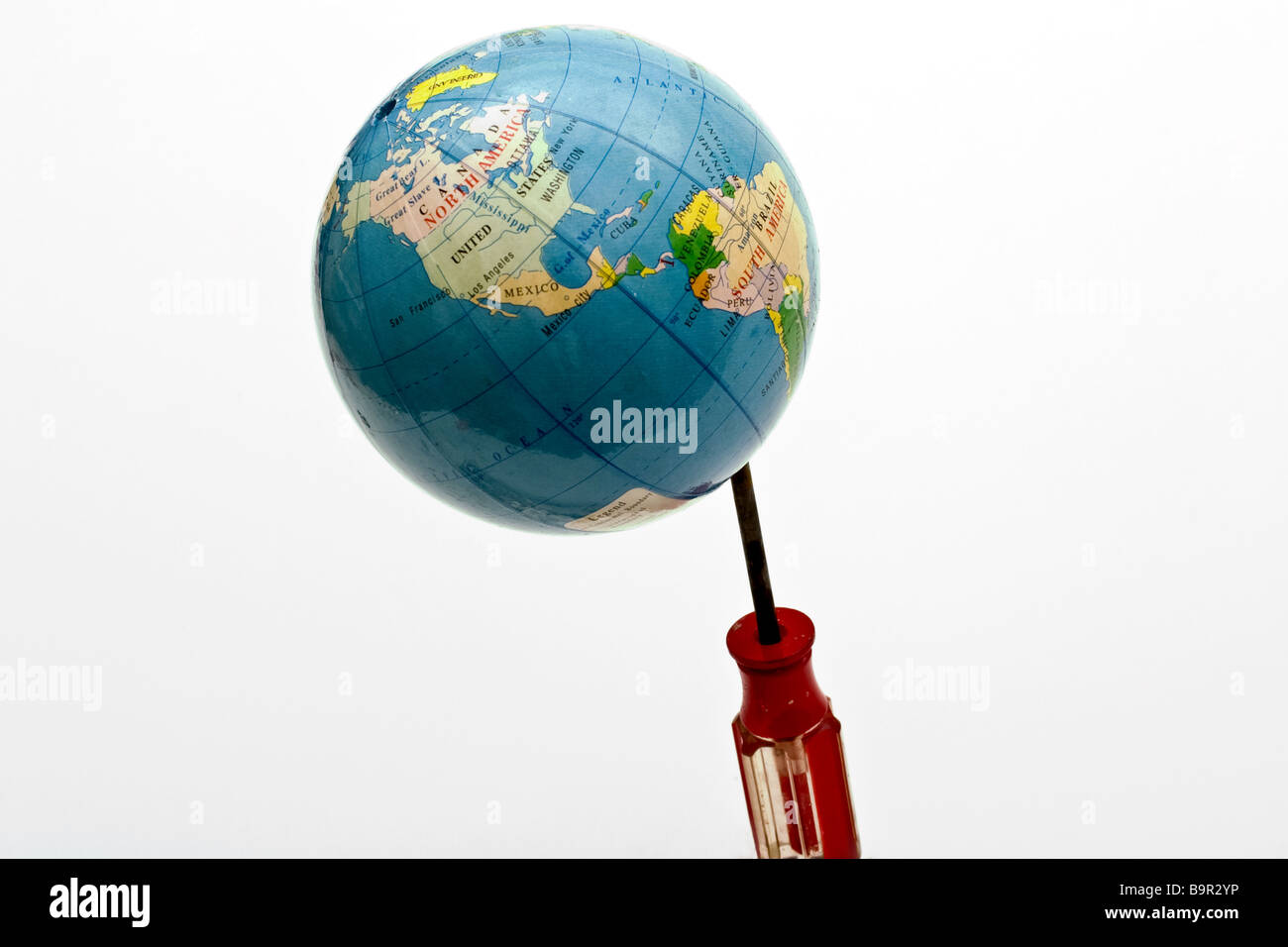 Small plastic globe held up by a screw driver Stock Photo - Alamy