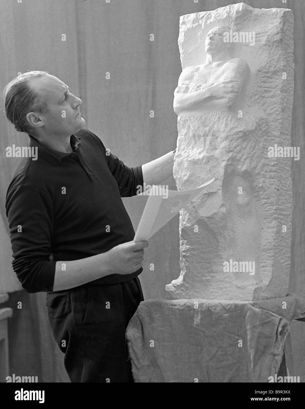 Sculptor Vladimir Tsygal and a working model of a monument to ...