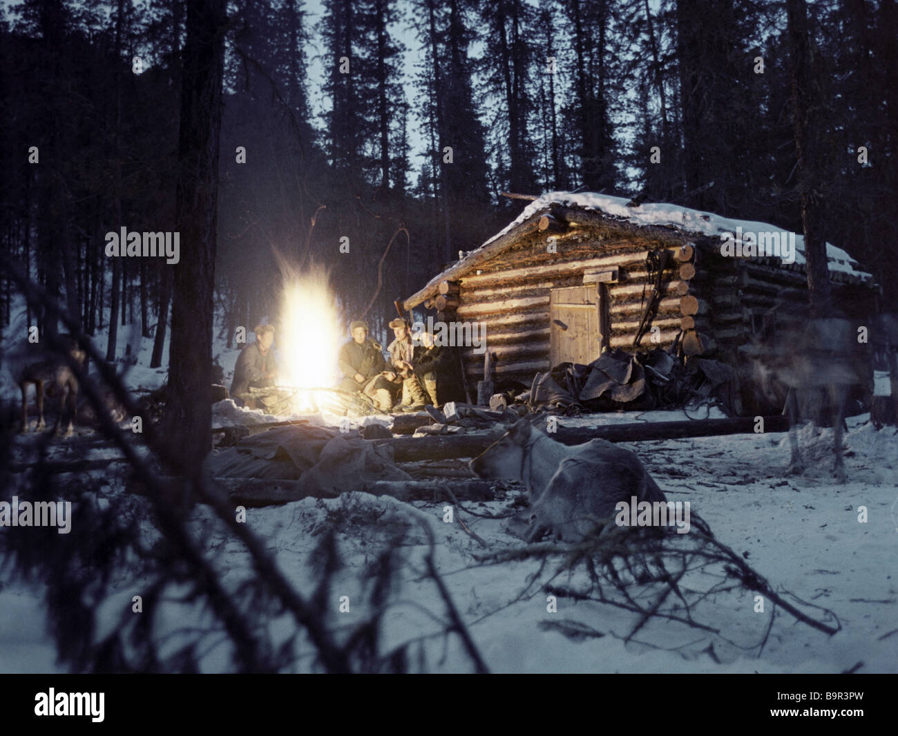 Hunters relaxing near a taiga retreat East Sayan Mountains Siberia ...