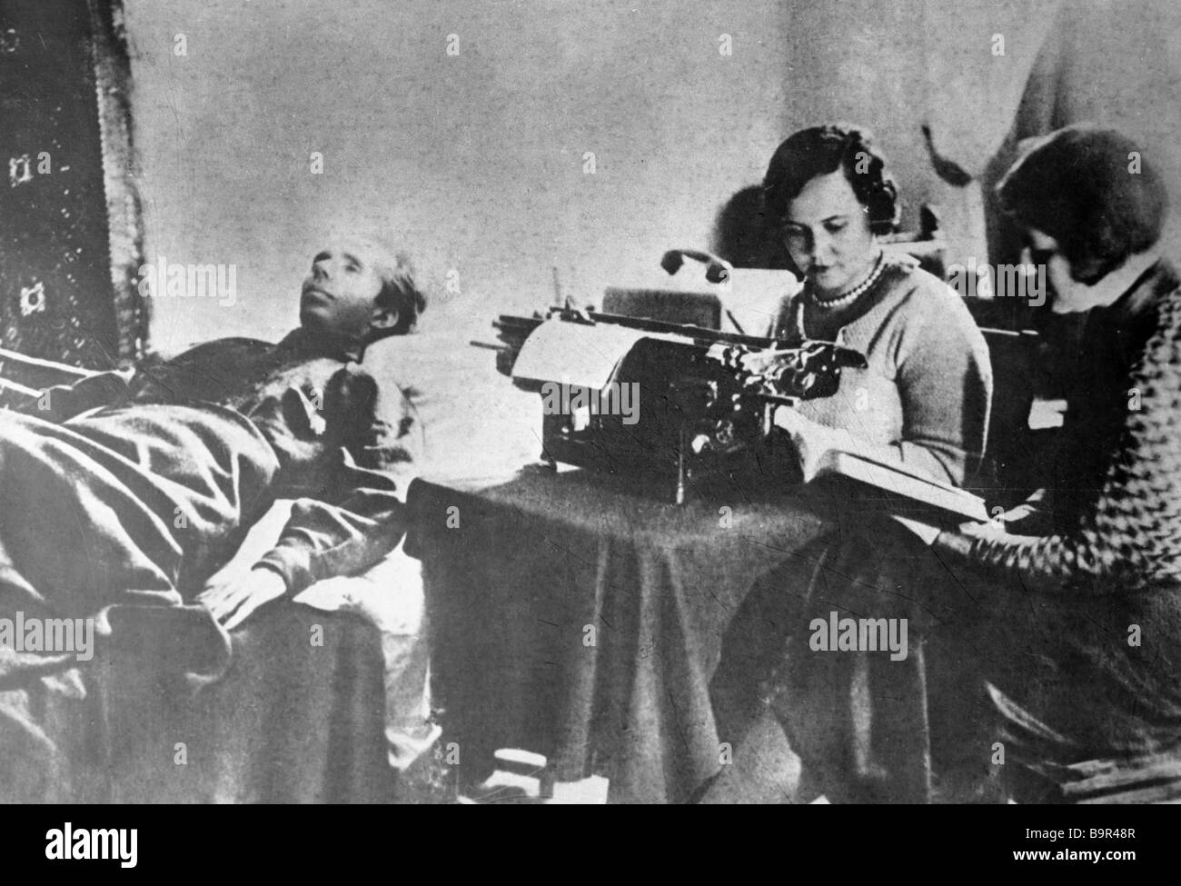 Soviet writer Nikolai Ostrovsky left prone dictating his book to a ...