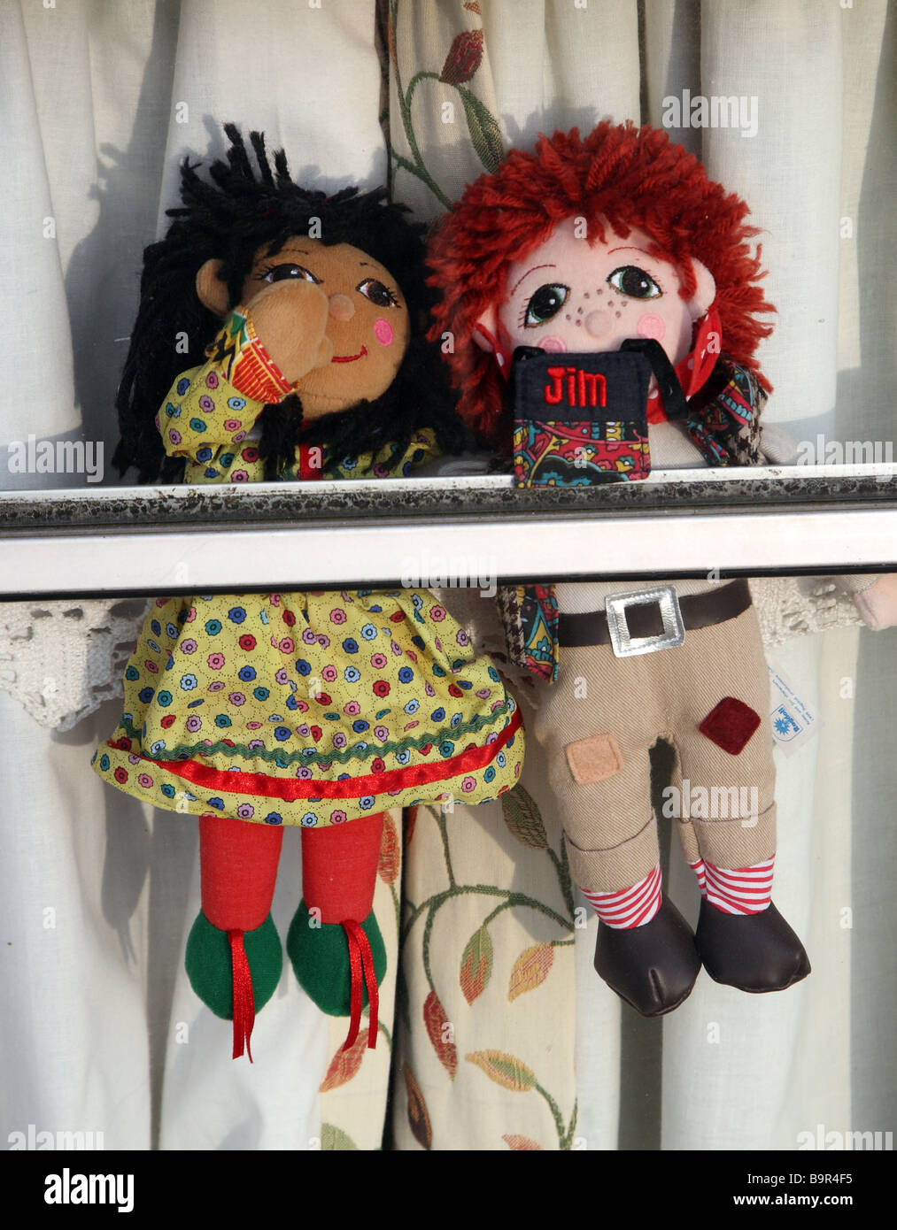 dolls at window of narrow boat Stock Photo - Alamy