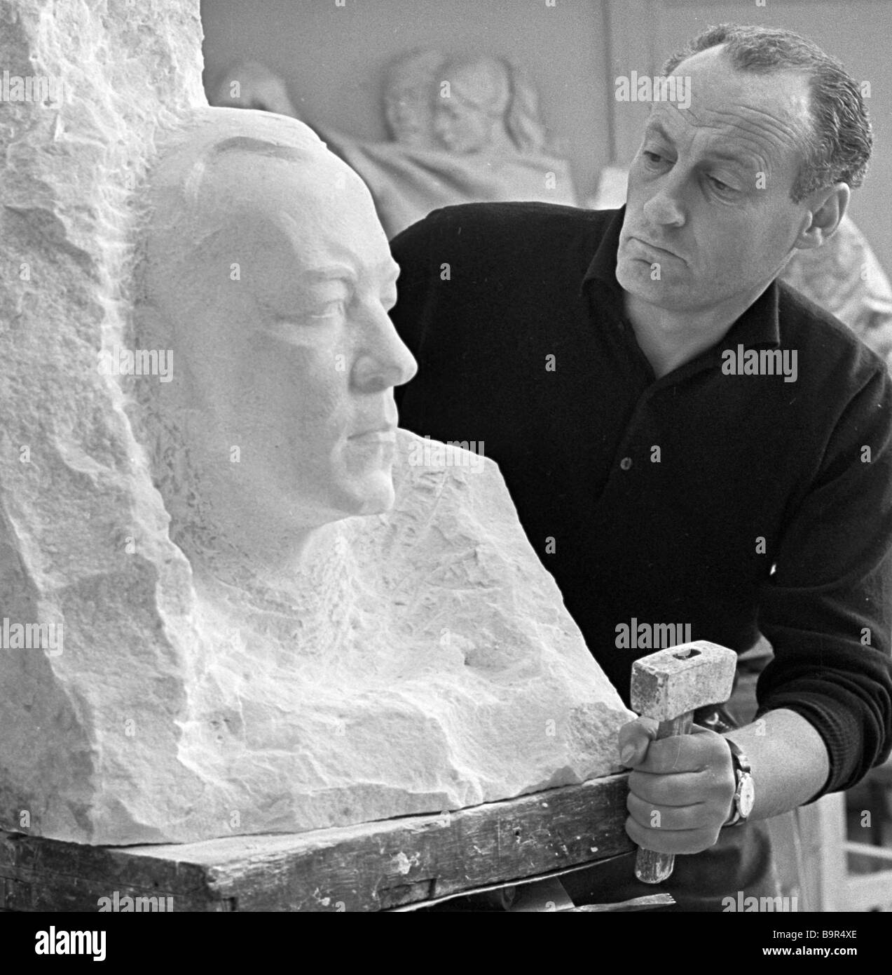 Soviet sculptor Vladimir Tsigal working at a portrait of WWII hero ...