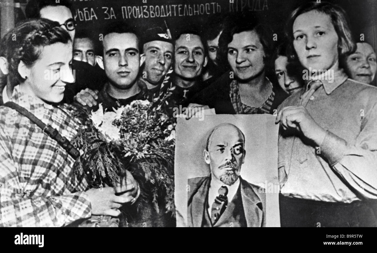 A worker at the Red Rose factory giving Spanish Komsomol members a silk ...