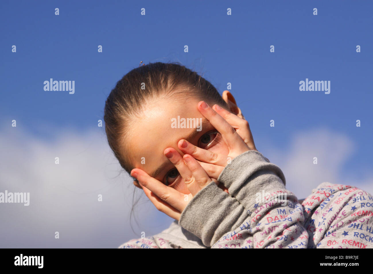 Scared young child hiding eyes hi-res stock photography and images - Alamy