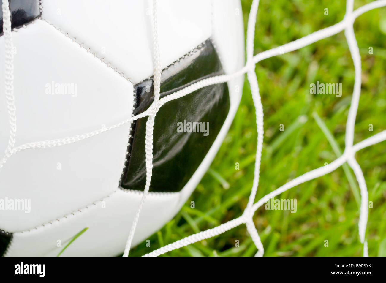 Soccer ball in goal net close up Stock Photo - Alamy