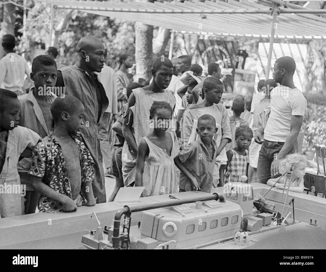 Bamaco children examine display stands at a Soviet commercial and ...