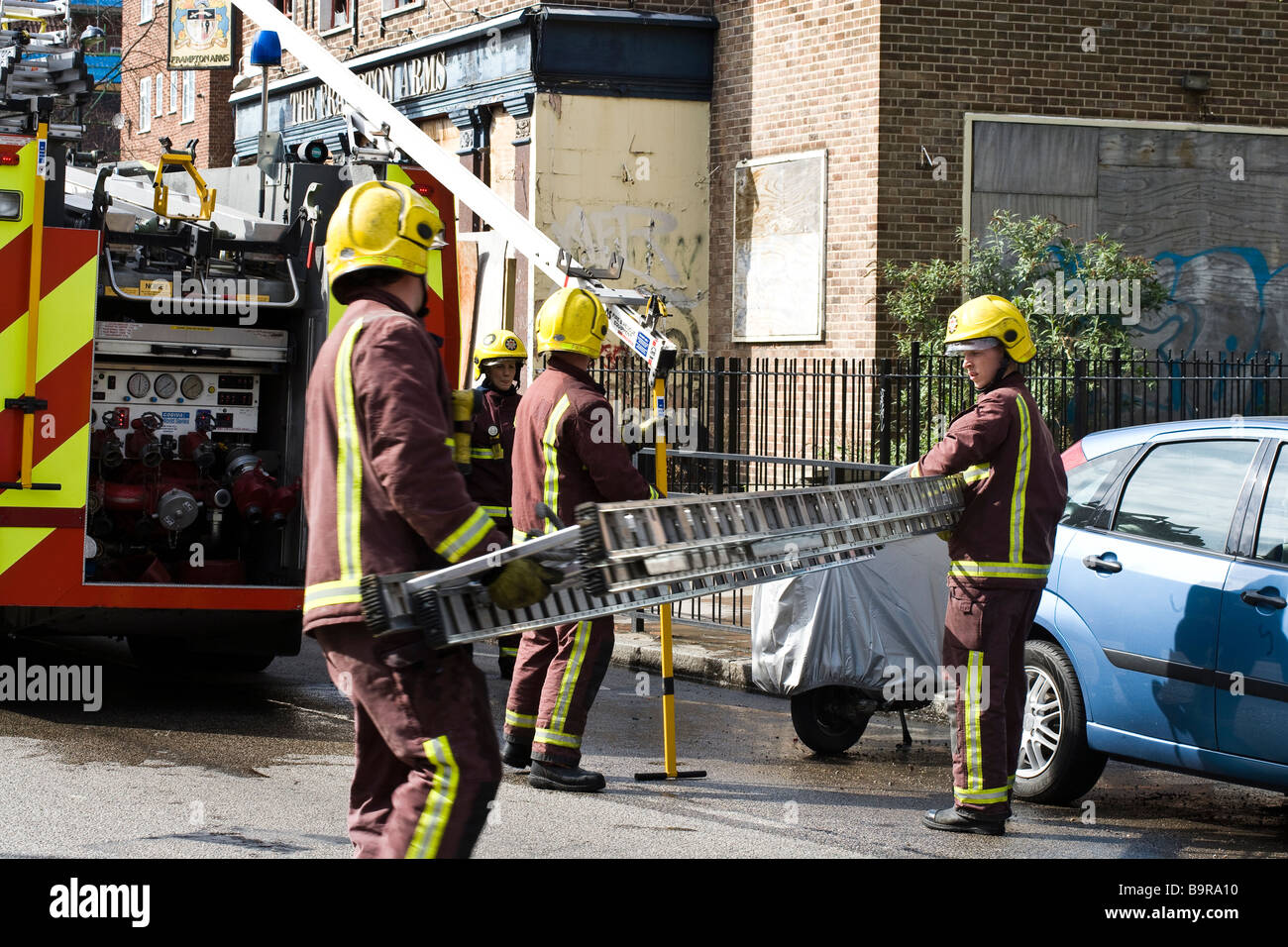Ladder uk engine fire men fire woman Stock Photo - Alamy