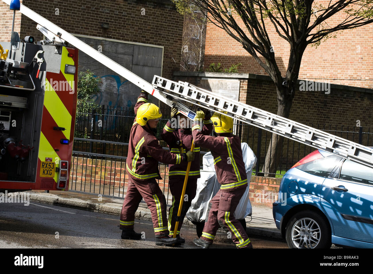 Ladder uk engine fire men fire woman Stock Photo - Alamy