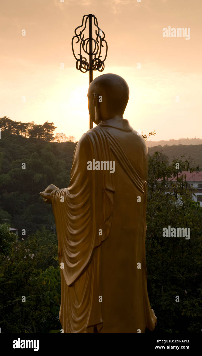 golden statue of bodhisattva, holy man, in Buddhism, from back against ...