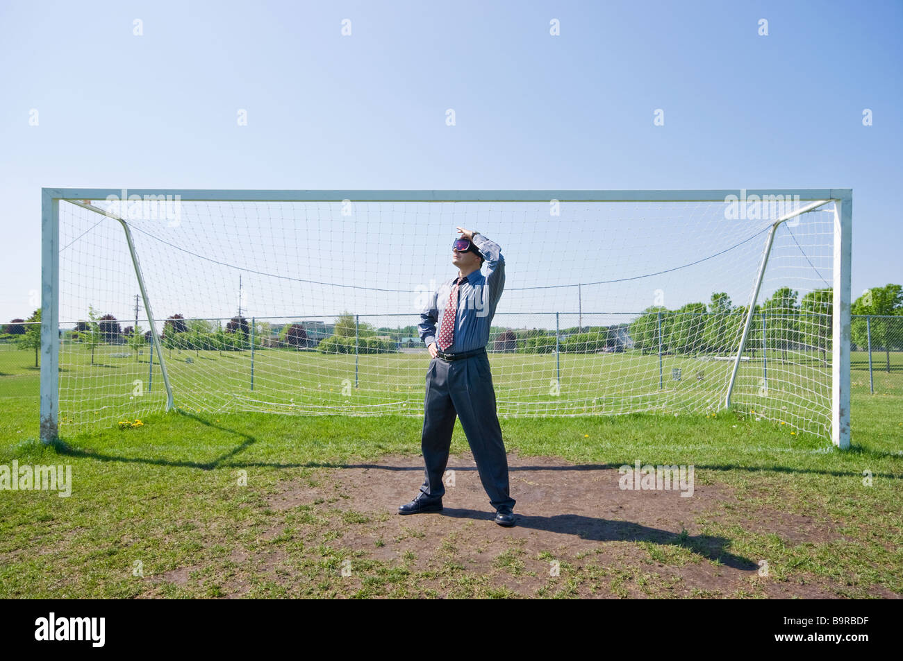 Office worker with goggles defending the soccer goal net Stock Photo ...