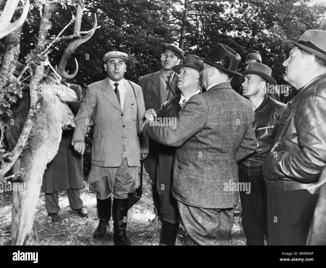 Nikita Khrushchev center and Iosip Broz Tito standing with his back ...