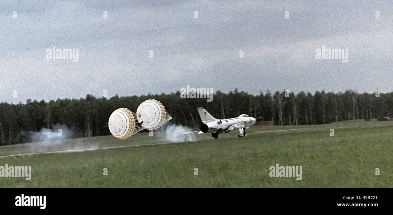A MiG 21 supersonic fighter aircraft with drag chutes landing at ...