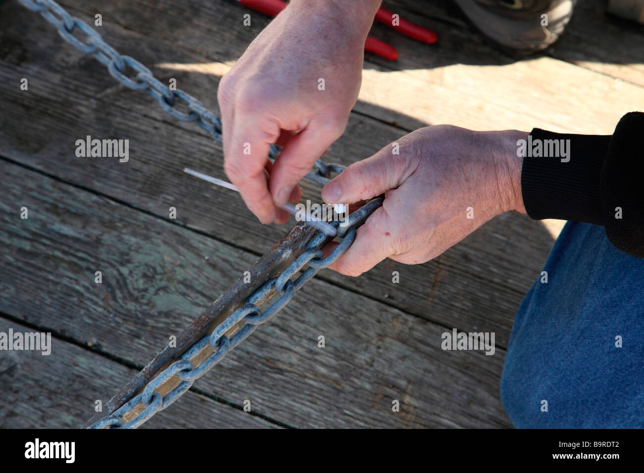 mans hands holding chain Stock Photo - Alamy