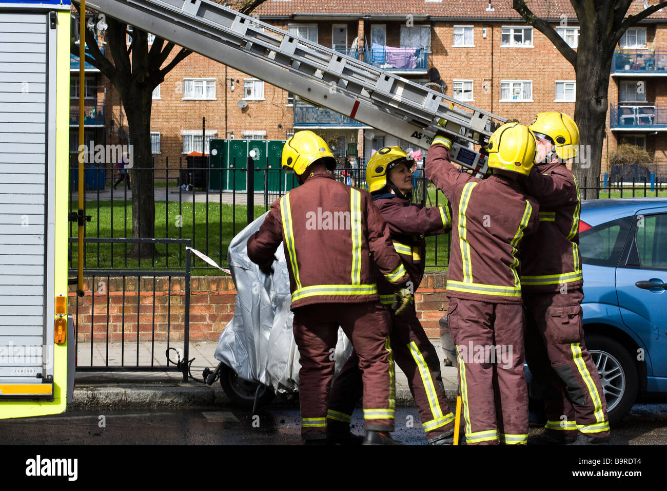 Ladder uk engine fire men fire woman Stock Photo - Alamy
