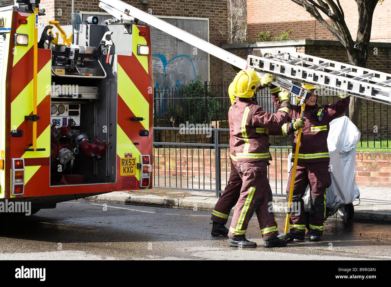 Ladder uk engine fire men fire woman Stock Photo - Alamy