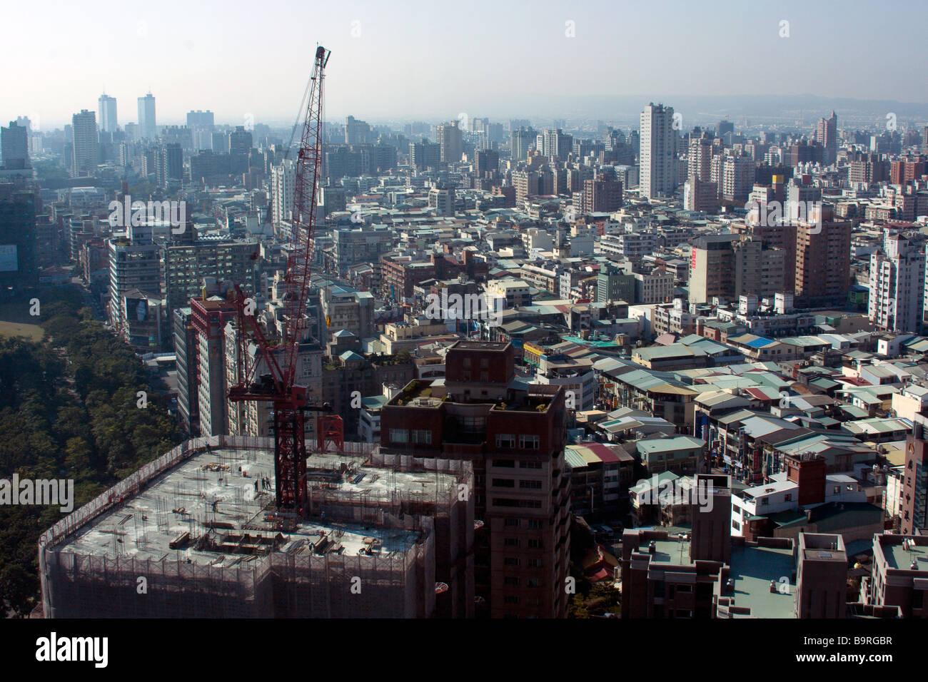 Construction tower crane on top of a building under construction with ...