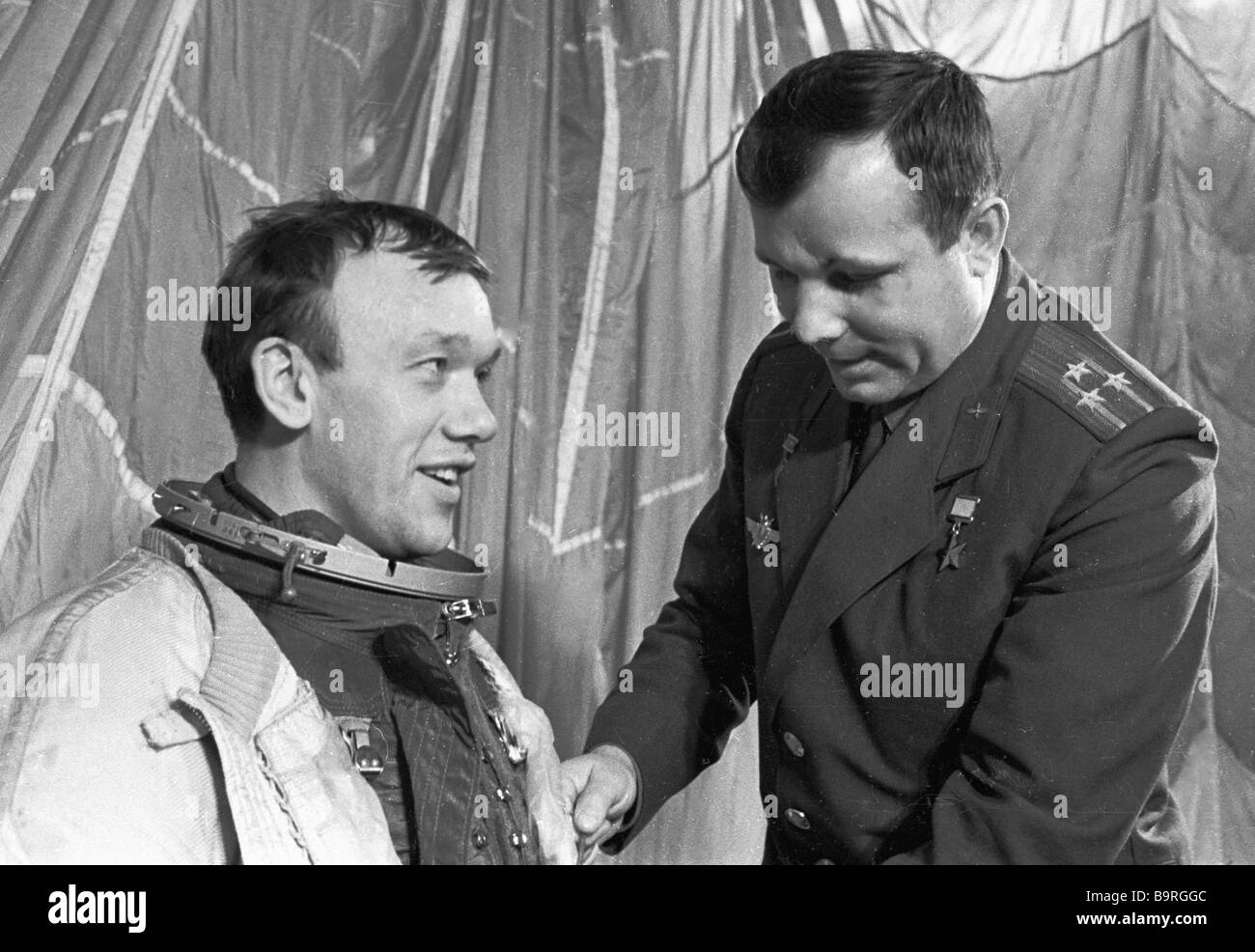 Pilot Cosmonaut of the U S S R Yury Gagarin right examines space suit ...